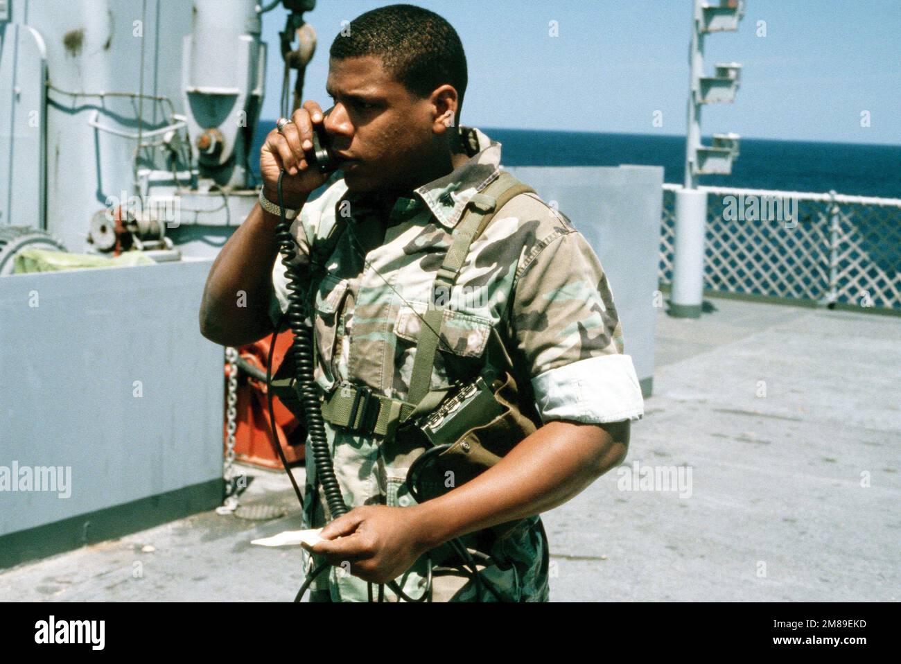 A Marine transmits information aboard the aviation logistic ship USNS ...