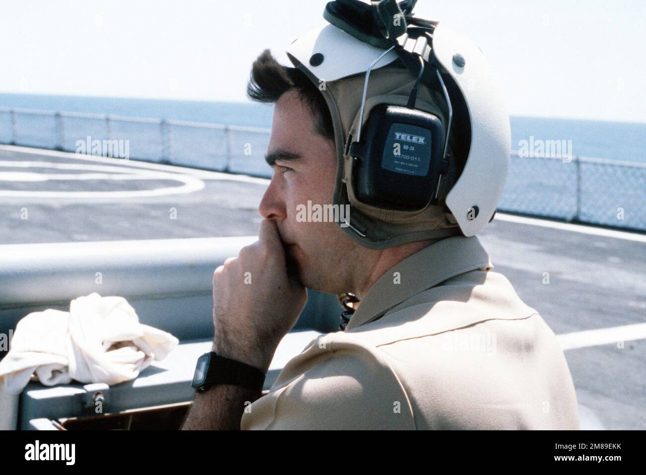 A flight officer communicates information aboard the flight deck of the ...