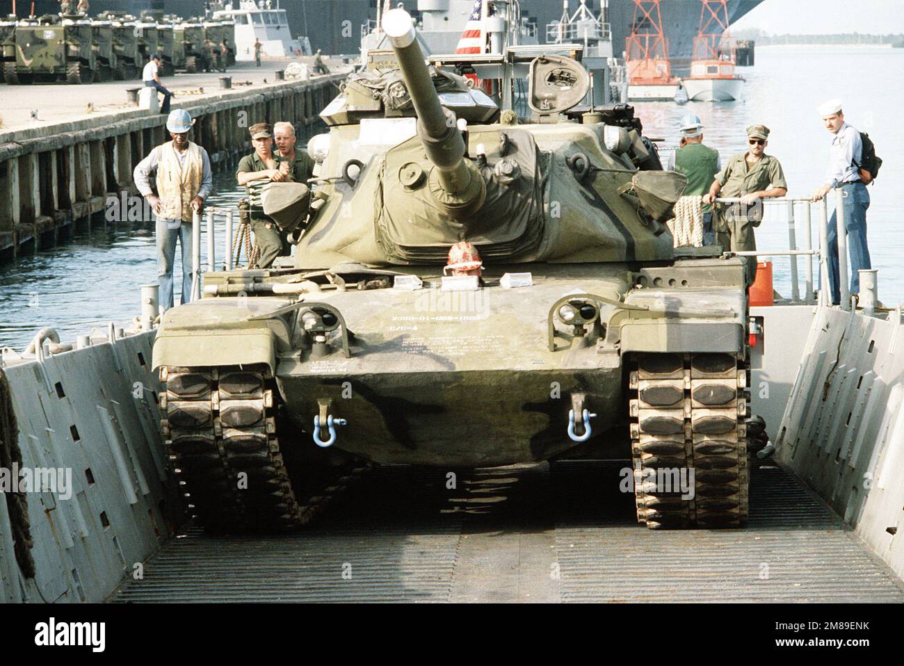 An M-60A1 tank is driven off an LCM-8 mechanized landing craft during ...