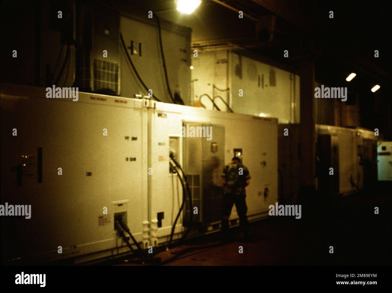 A Marine checks an outlet on a shelter in the cargo hold of a Waterman ...