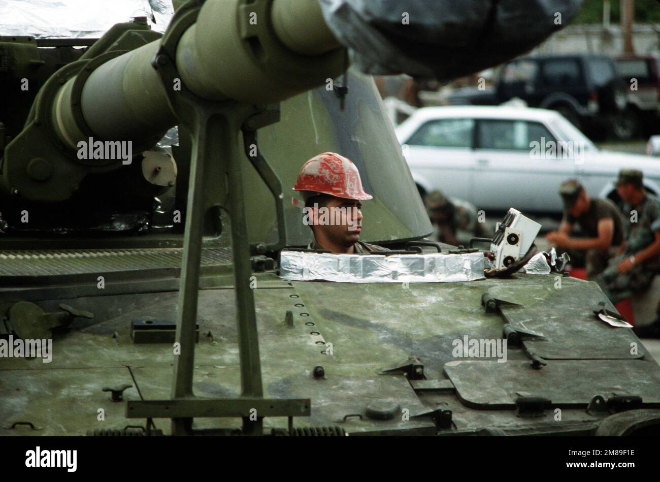 A Marine maneuvers an M-198 155mm self-propelled howitzer down a ...