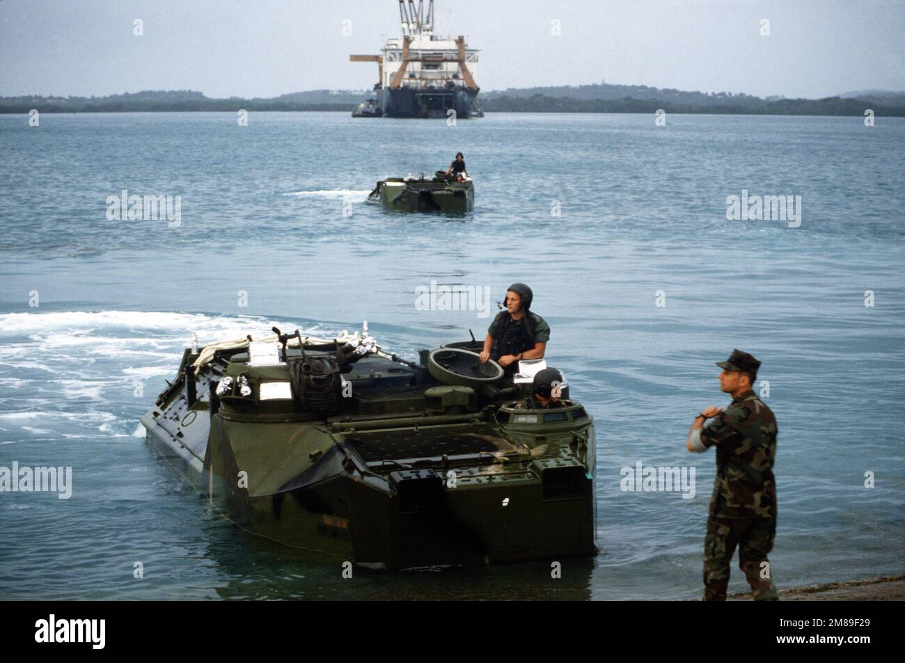 Marines come shore in AAVP-7A1 assault amphibian vehicles as a harbor ...