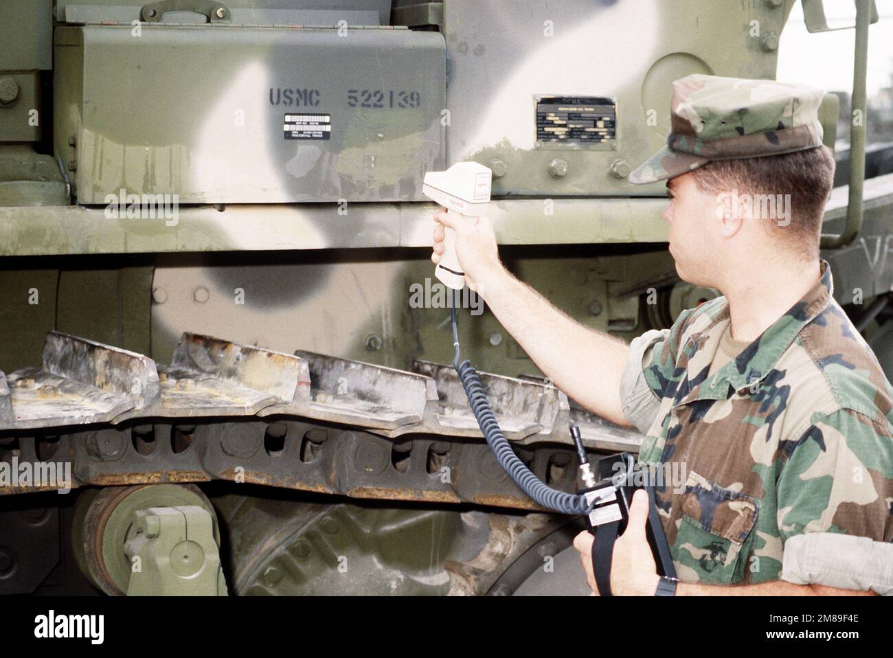 A Marine scans the computer bar code printed on a plate attached to the ...