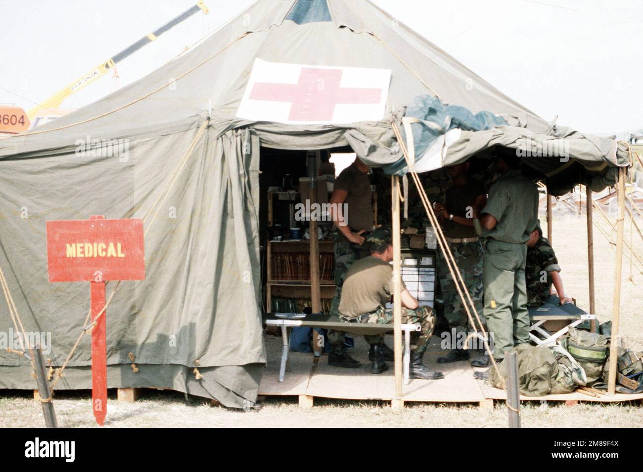 Navy and Marine Corps personnel confer in a medical tent during ...