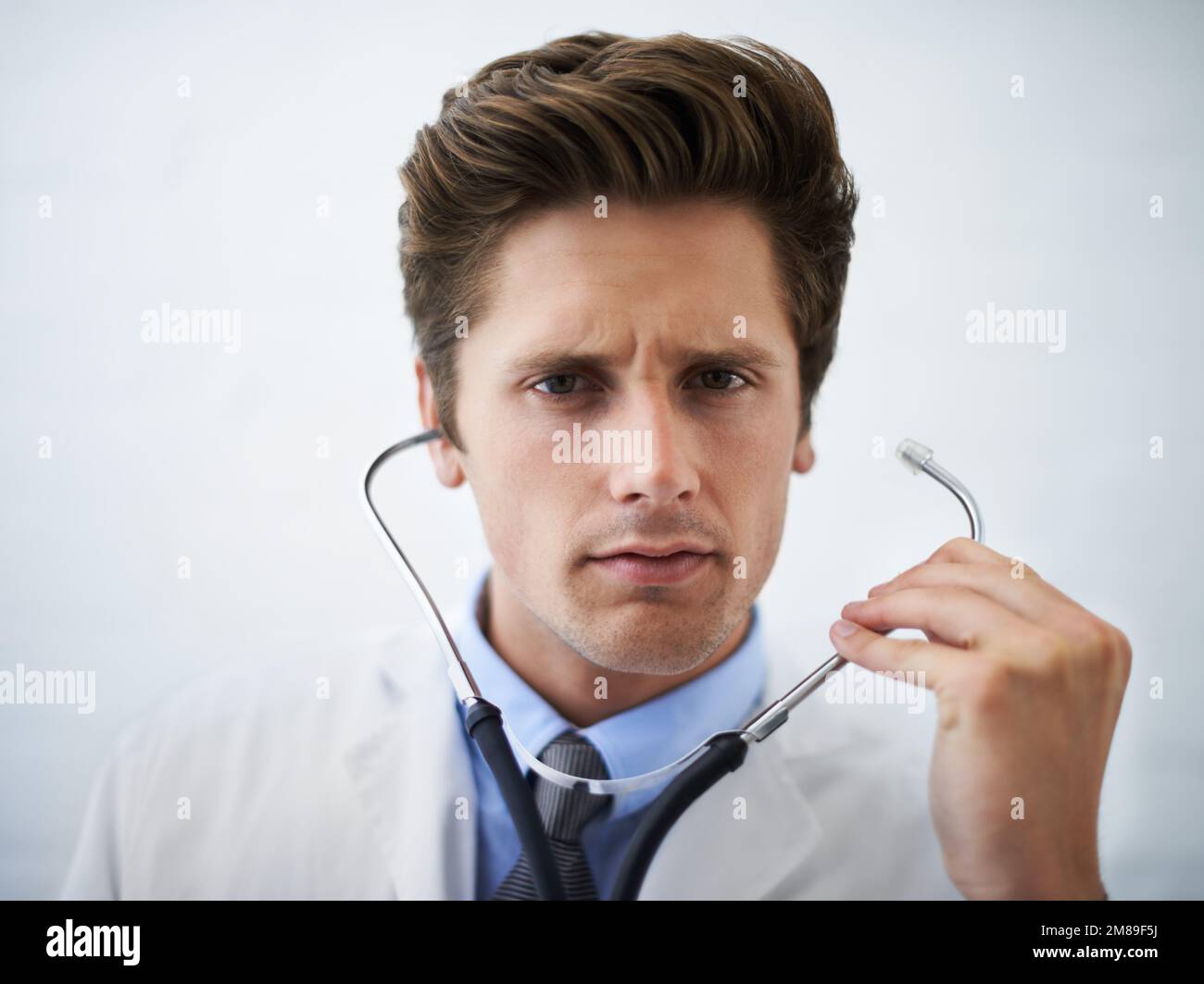 I think there may be a problem...Closeup portrait of a young doctor ...