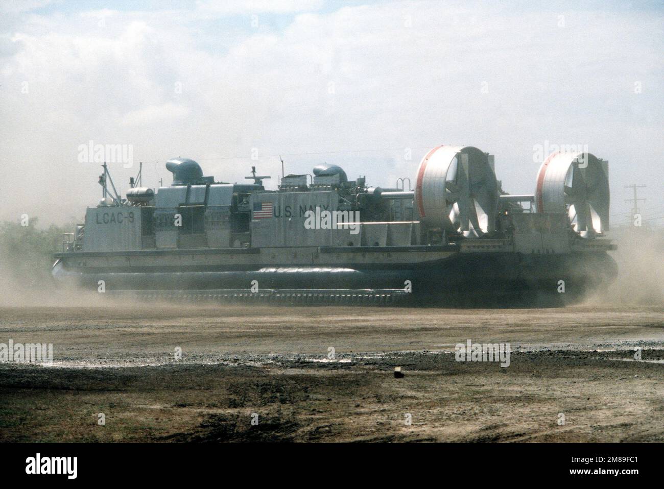 The air cushion landing craft LCAC-9 moves across the beach during ...