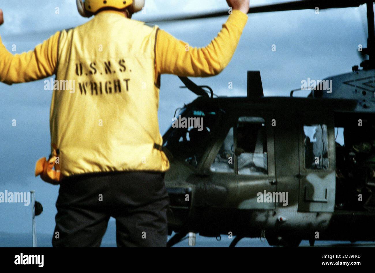 A plane director aboard the aviation logistic ship USNS WRIGHT (T-AVB 3 ...