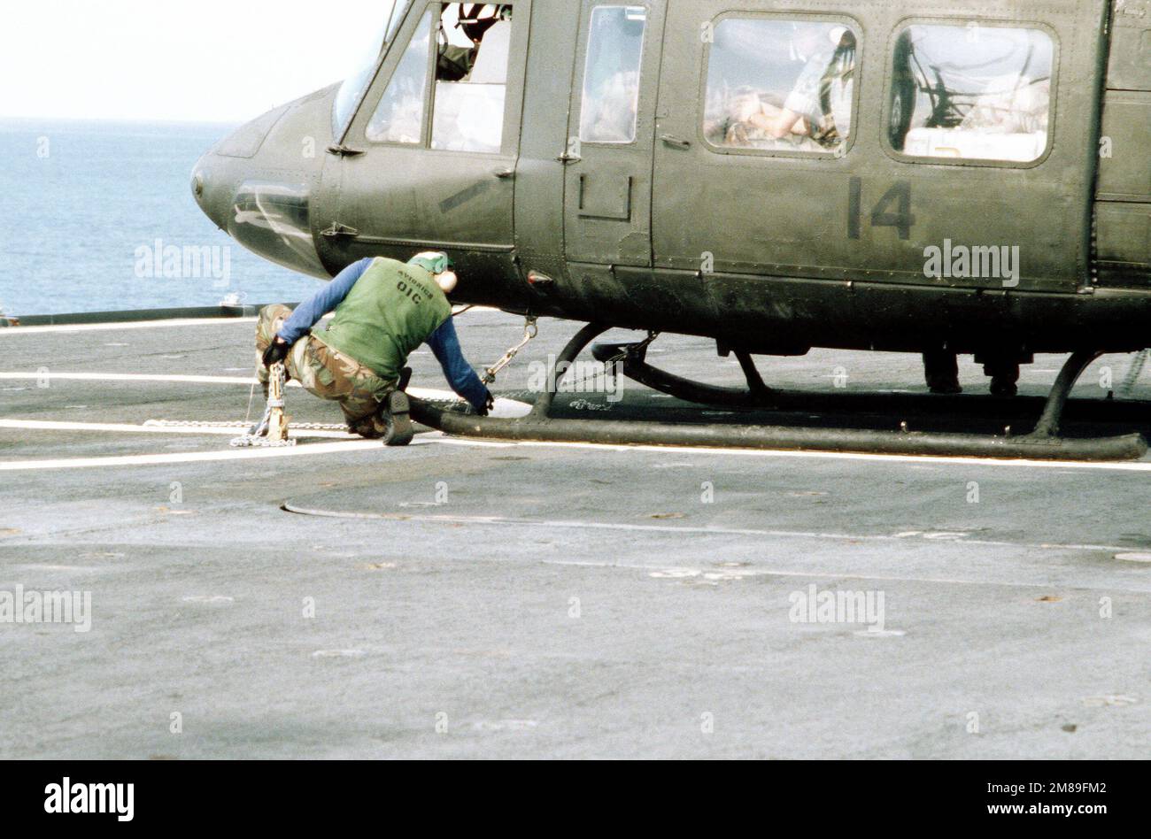 A Marine working on the flight deck of the aviation logistic ship USNS ...