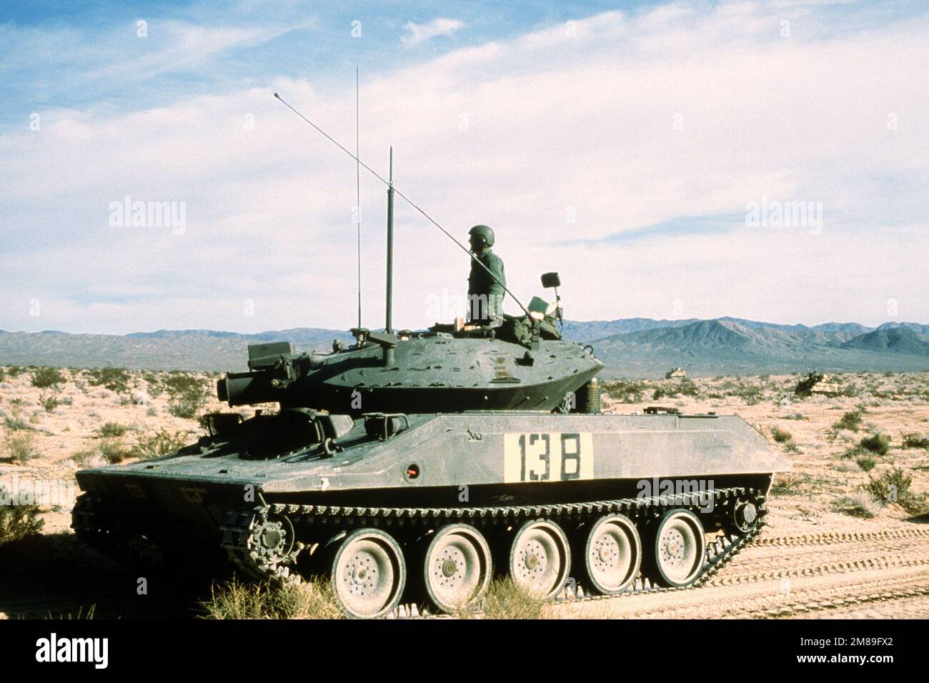 A soldier stands up in the turret of an M-551 Sheridan light tank ...