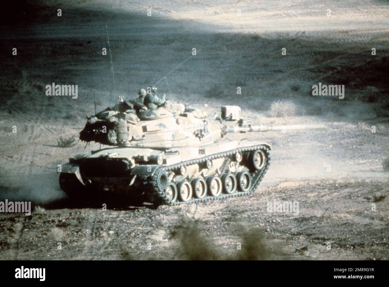 DA-ST-88-04822. An M60 main battle tank maneuvers through the desert ...