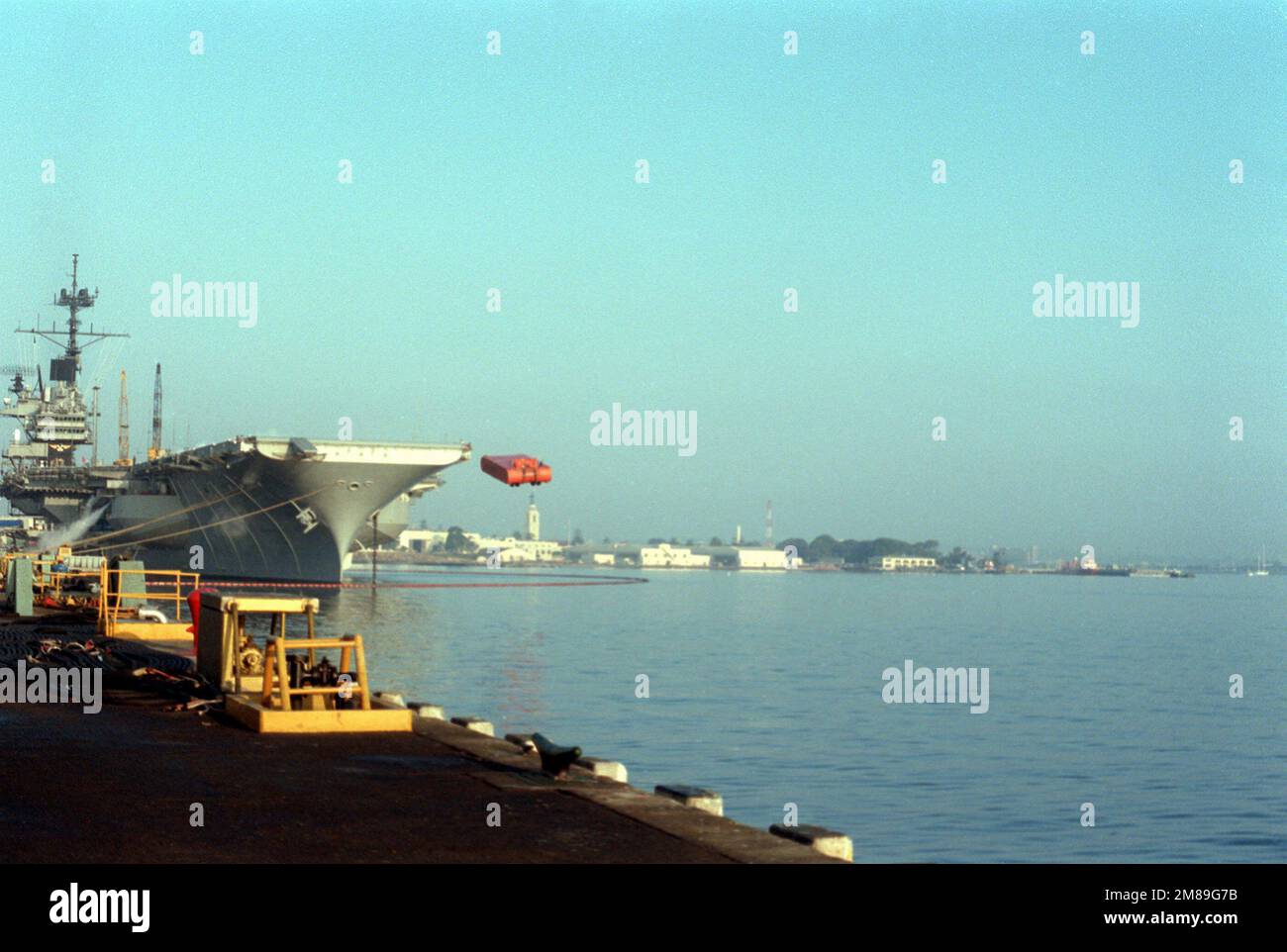 A starboard bow view of the aircraft carrier USS RANGER (CV-61) tied to ...
