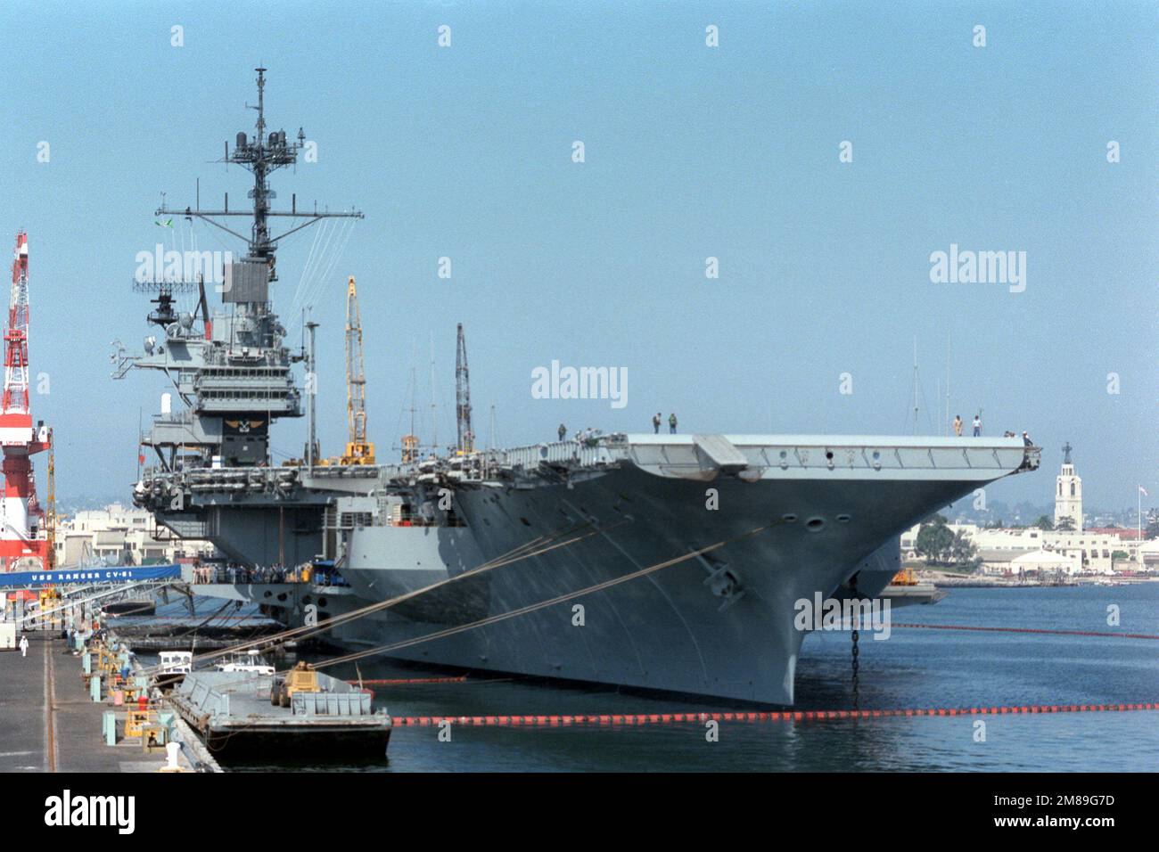 A starboard bow view of the aircraft carrier USS RANGER (CV-61) tied to ...