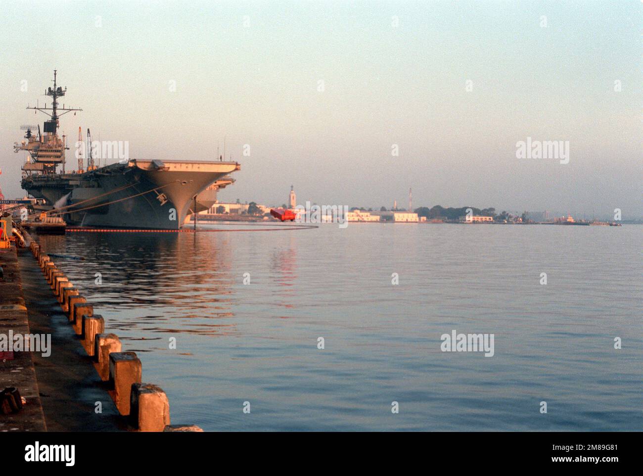 A starboard bow view of the aircraft carrier USS RANGER (CV-61) tied to ...