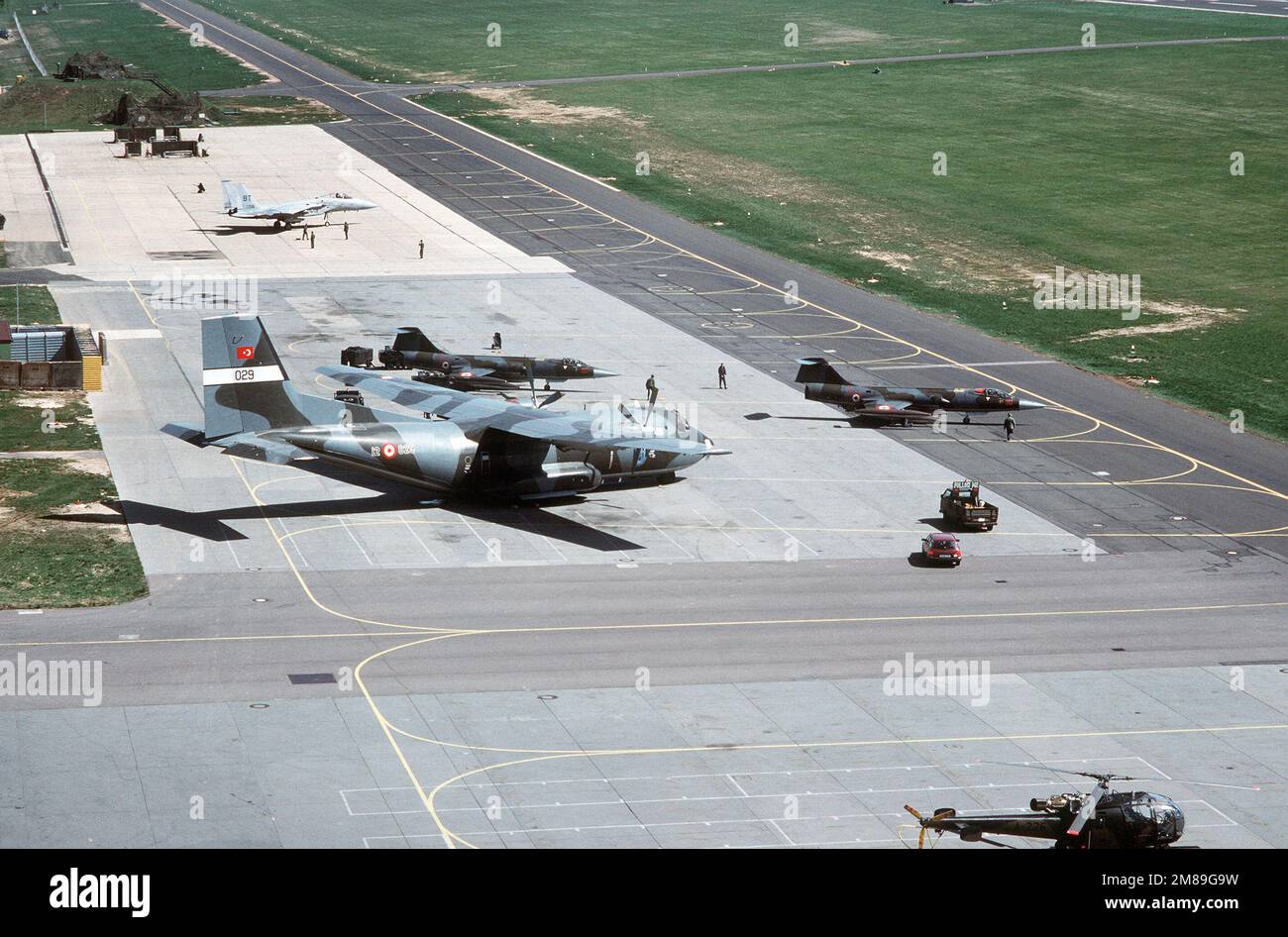 Two Italian air force F-104S Starfighter aircraft, center, taxi past a ...