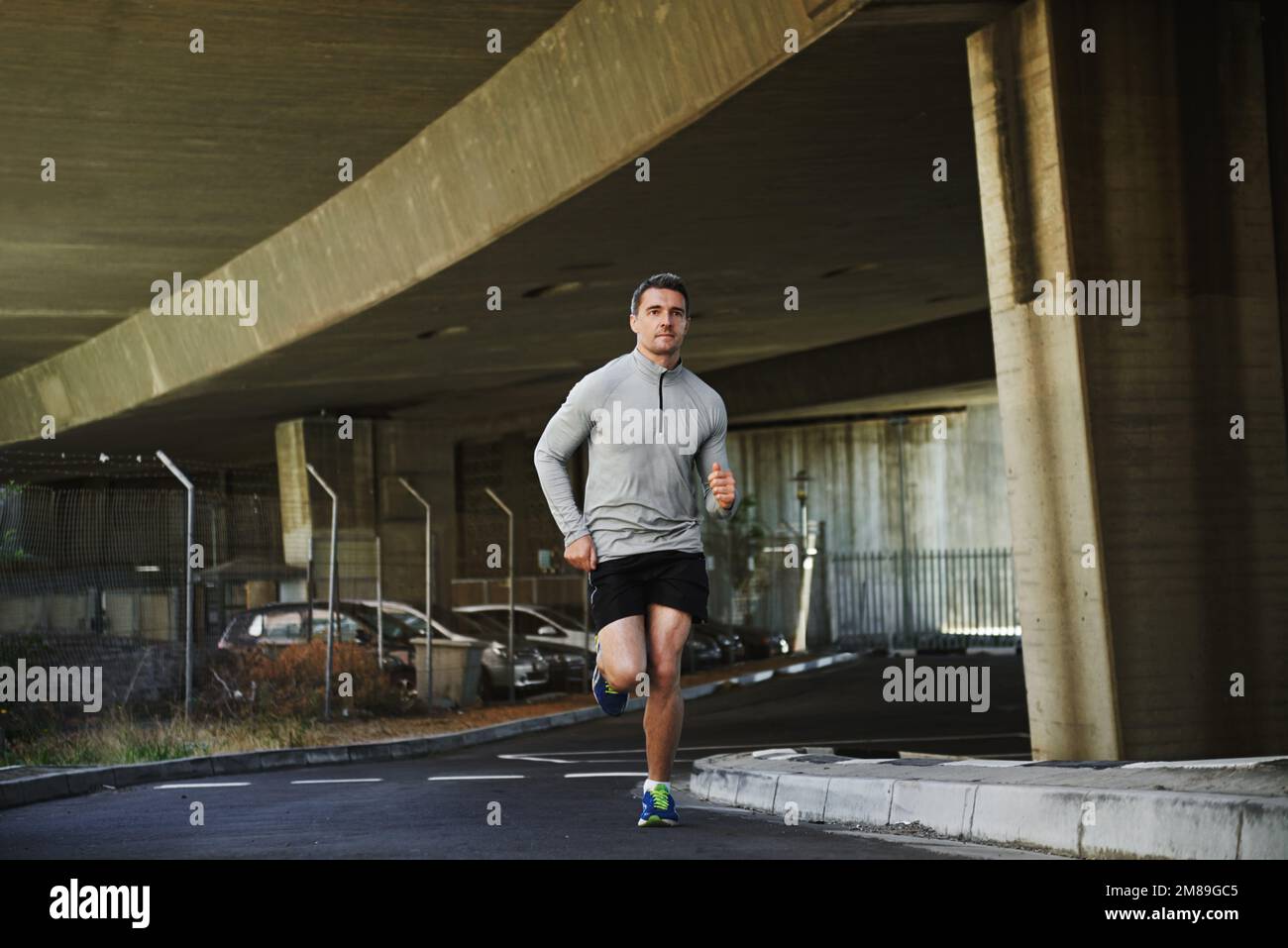 Keeping the heart pumping. Fit young man going for a run in the city ...