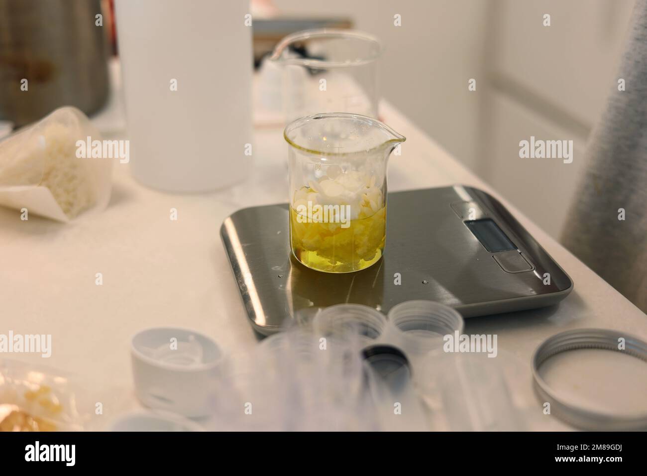 Weigh ingredients in the beaker on the electronic scale in the ...