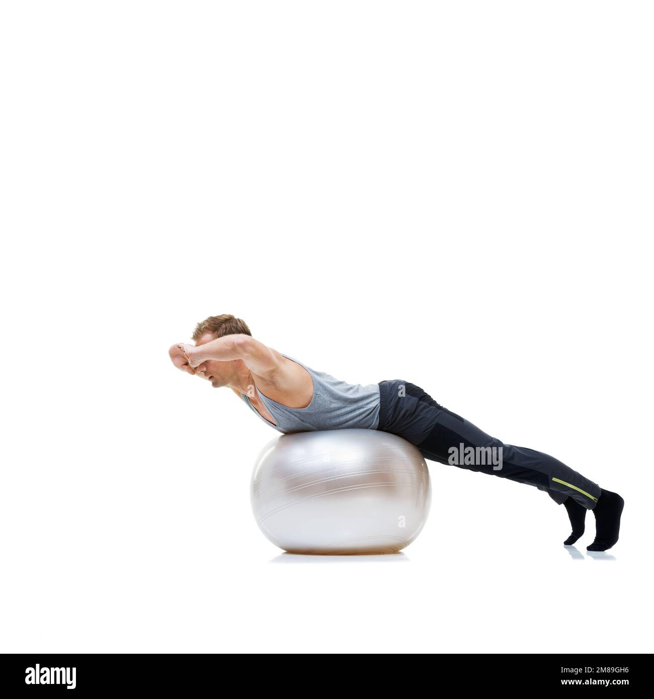 Balance is key. a man balancing on an exercise ball with a white ...