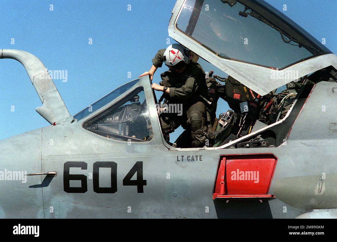 A pilot from Tactical Electronic Warfare Squadron 140 (VAQ-140) climbs ...