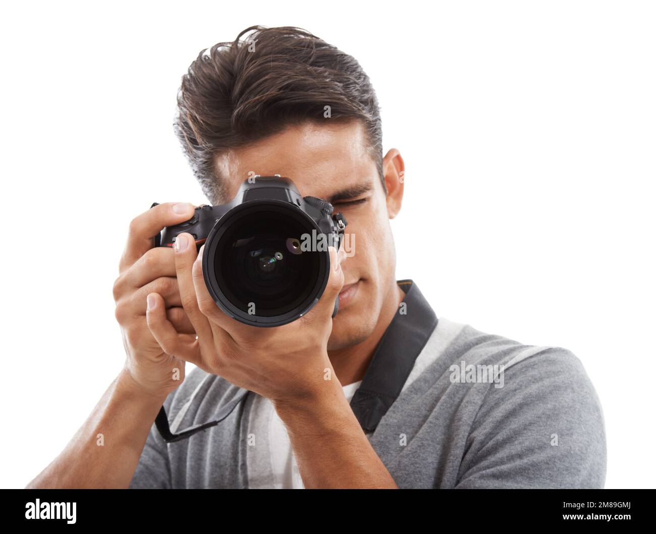 Take your best shot. Studio shot of a young man holding a camera ...