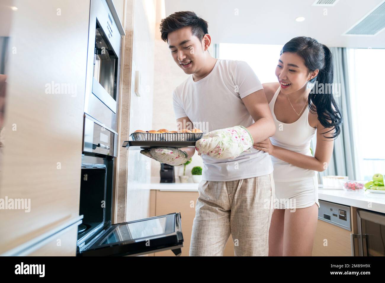 Young lovers baking bread in the kitchen Stock Photo - Alamy