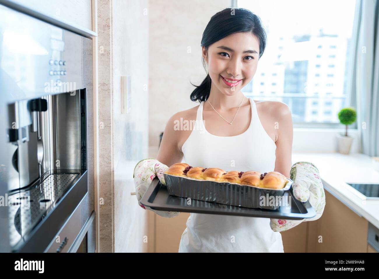 The young woman baking bread in the kitchen Stock Photo - Alamy
