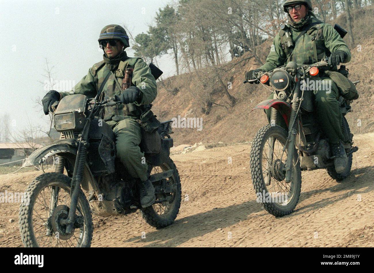 Two U.S. Army scouts ride their motorcycles during the joint South ...