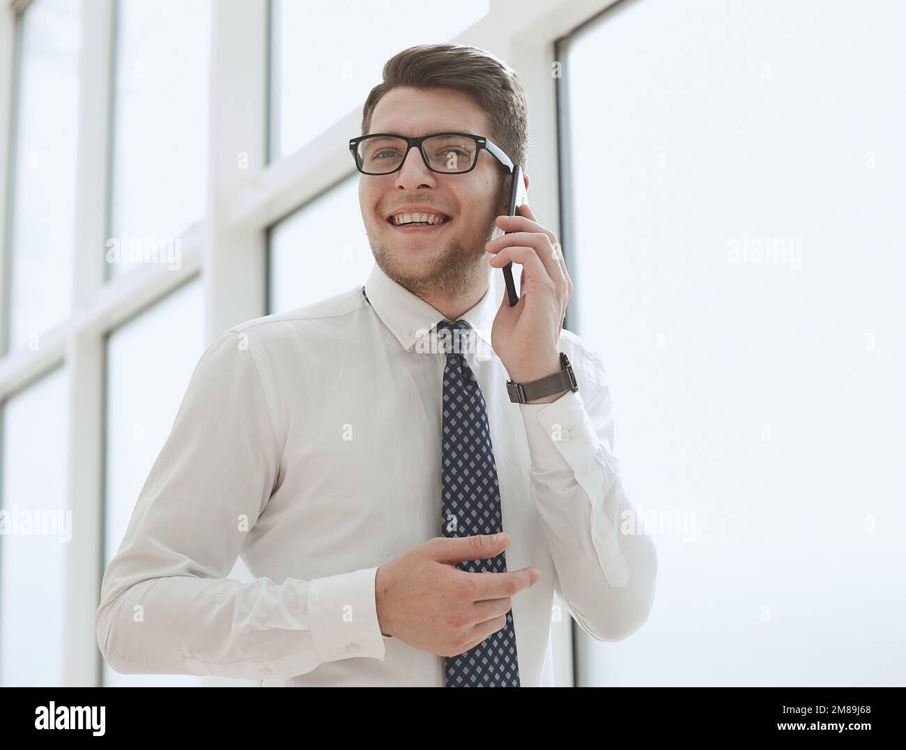 Businessman Making Phone Call In Office Stock Photo - Alamy