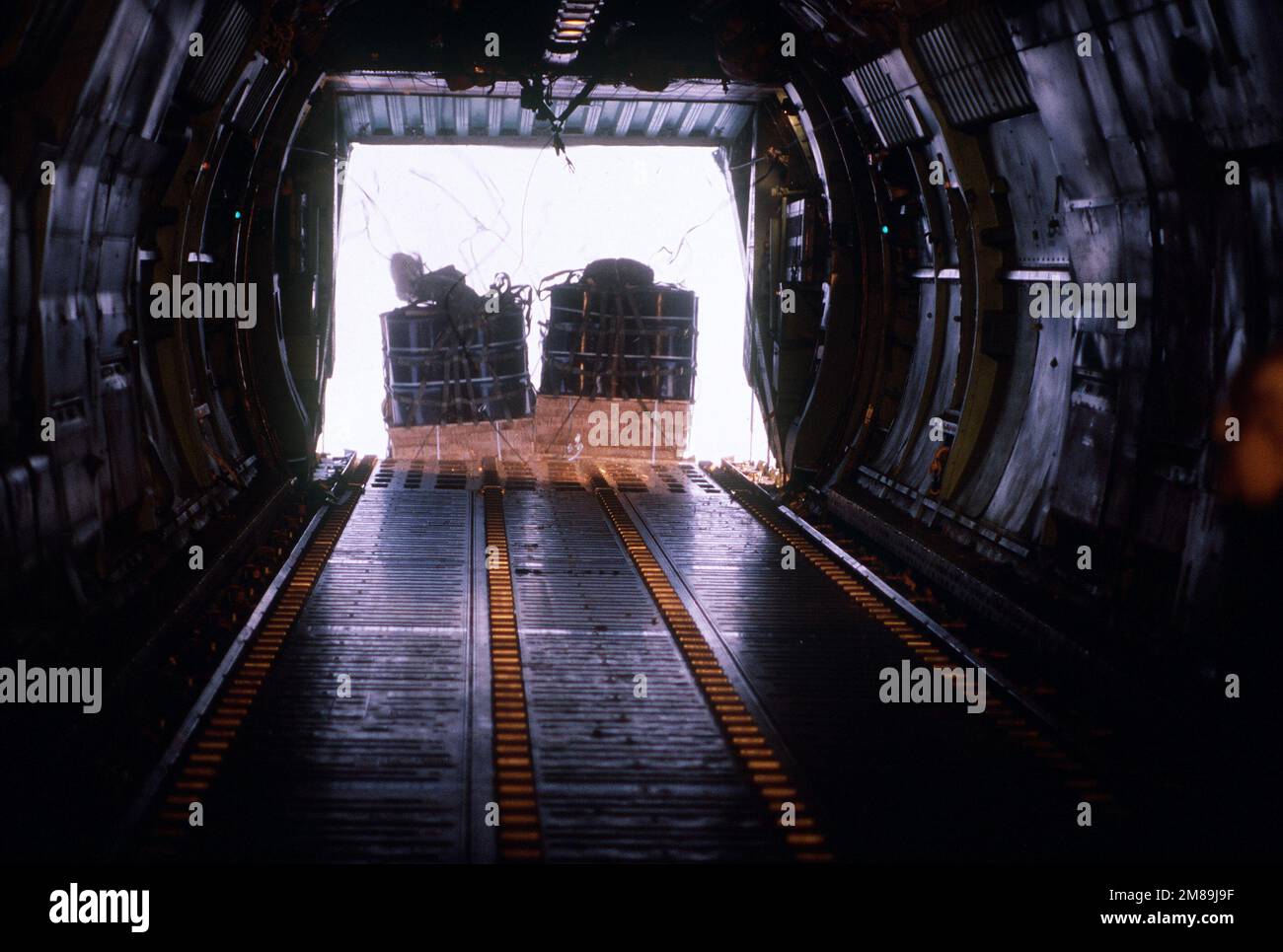 Fuel containers drop from a C-141B Starlifter aircraft during a ...