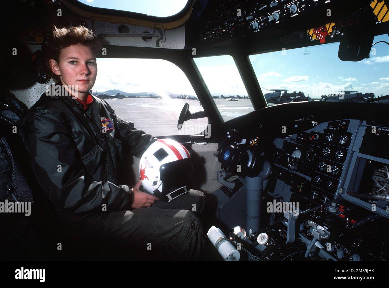 A female Navy pilot poses in the cockpit of a C-2A Greyhound aircraft ...
