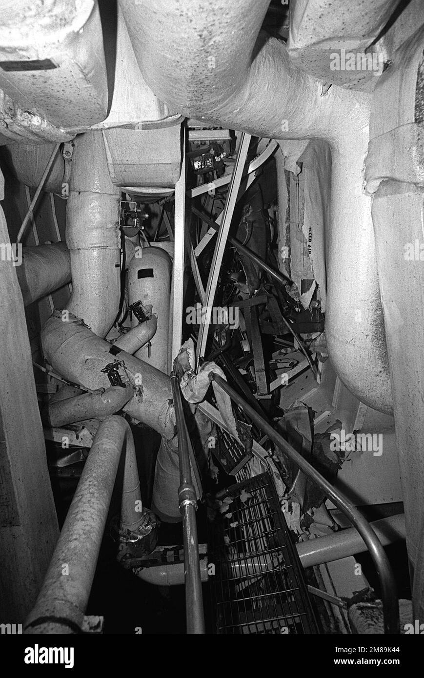 A close-up view of damage to part of the main engine room of the guided ...