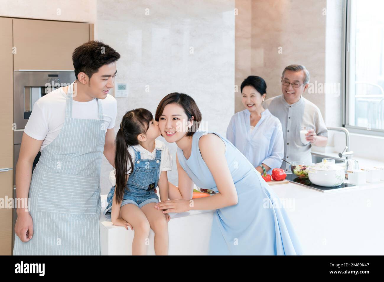 Happy family in the kitchen Stock Photo - Alamy