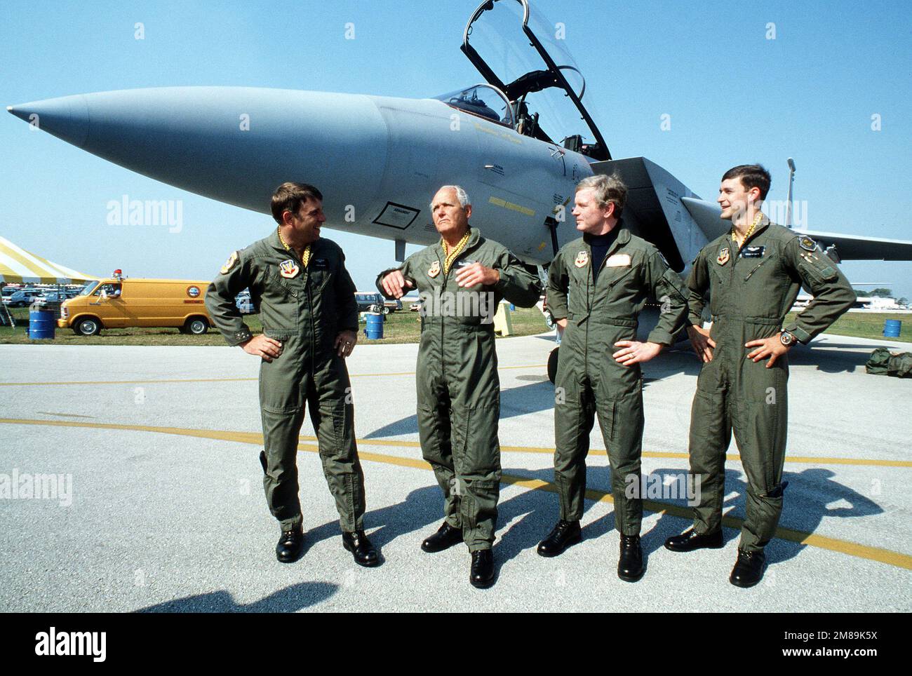 Standing in front of an F-15D Eagle aircraft are, from left to right ...