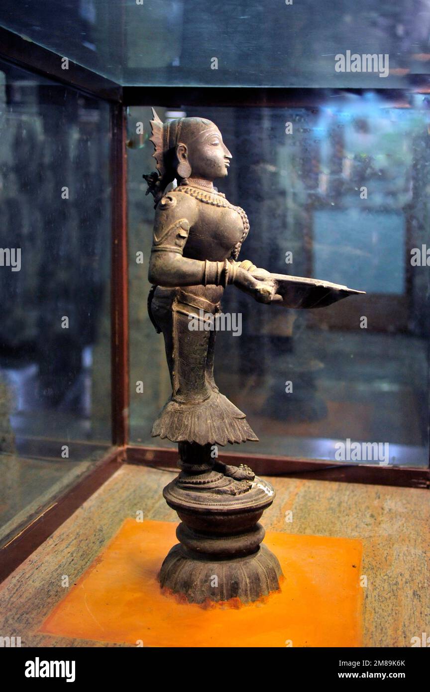 Sculpture of a Woman with lamp in bronze Chola dynasty in Meenakshi ...