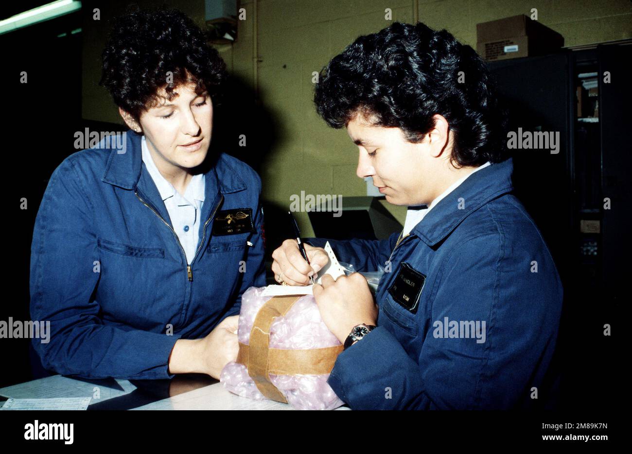 Aviation Storekeeper 1ST Class Kathy Burch issues supplies at the ...