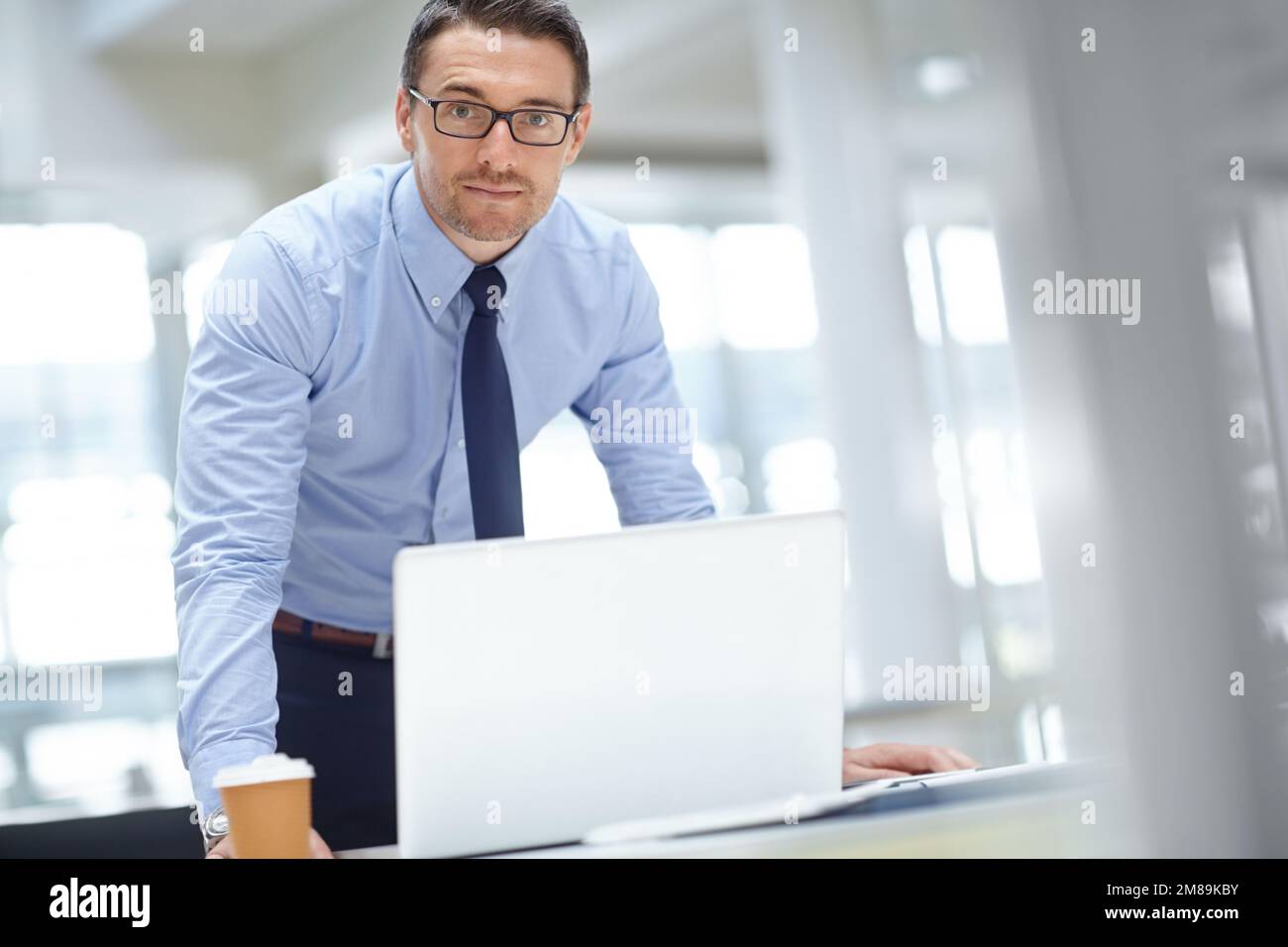 Portrait, laptop and mission with a business man at work in his office ...