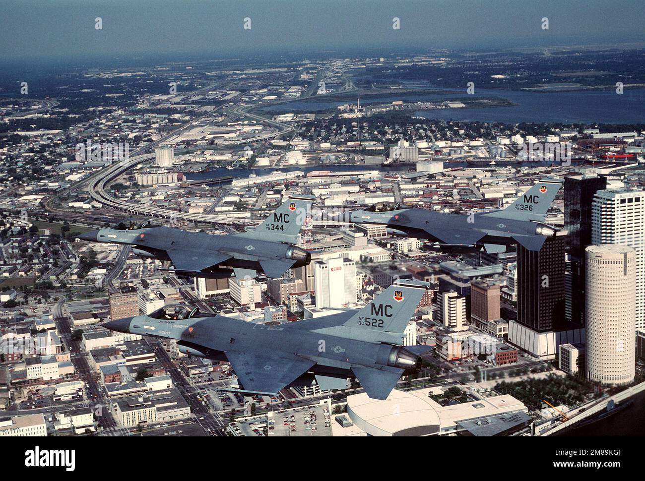An air-to-air left side view of F-16 Fighting Falcon aircraft flying in ...