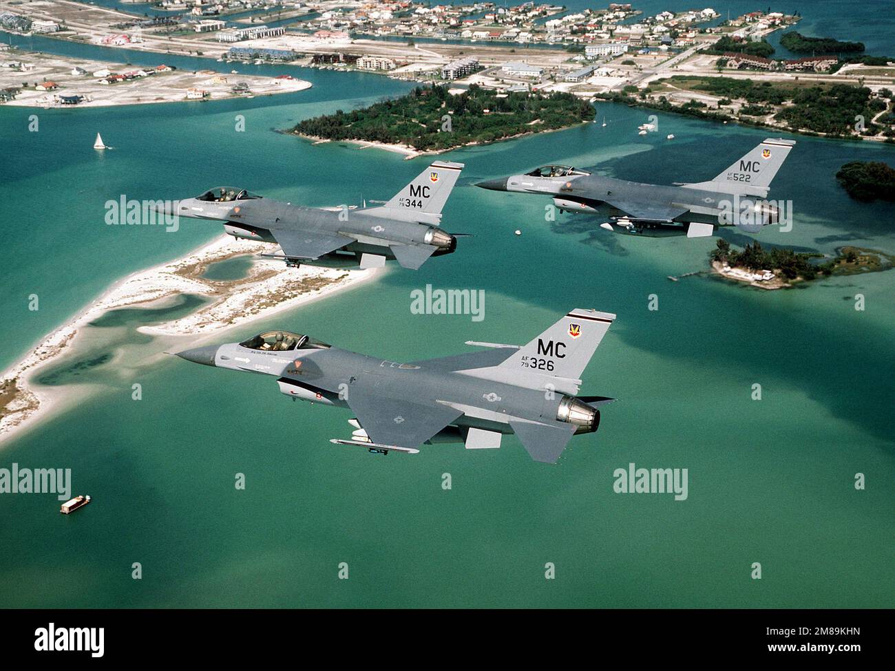 An air-to-air left side view of F-16 Fighting Falcon aircraft flying in ...