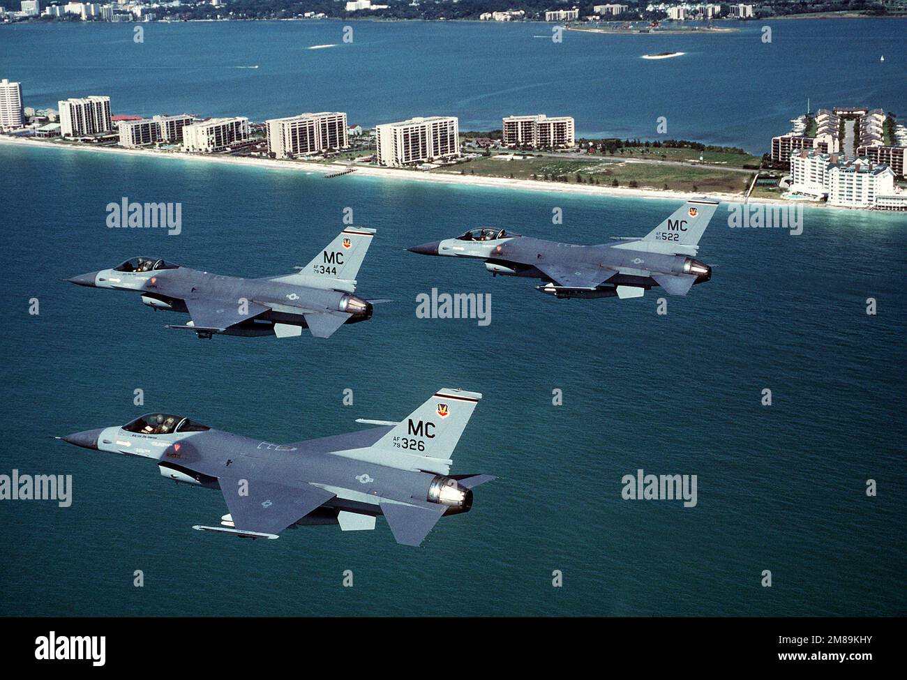 An air-to-air left side view of F-16 Fighting Falcon aircraft flying in ...