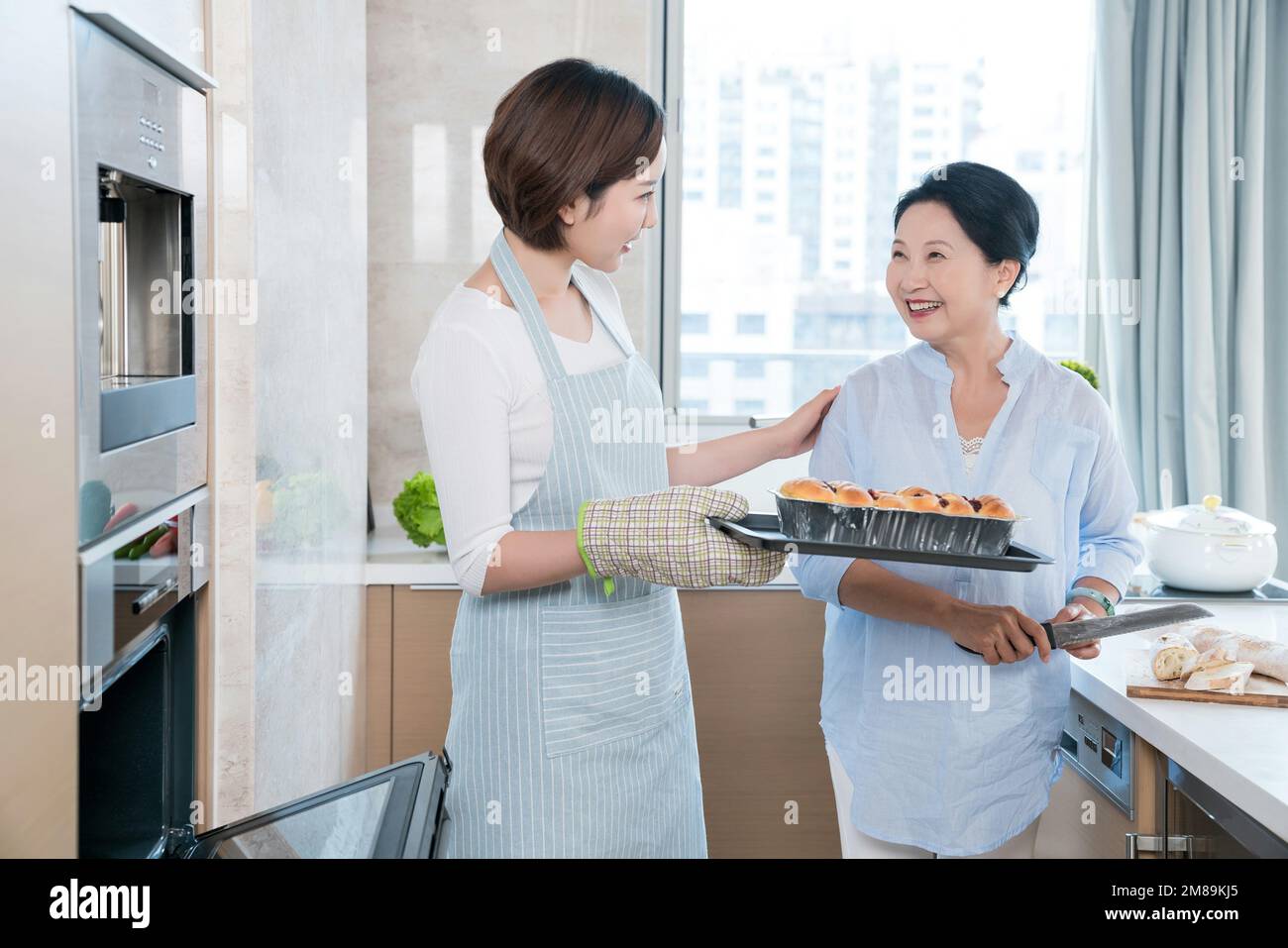 Mother and daughter two people bake bread in the kitchen Stock Photo ...