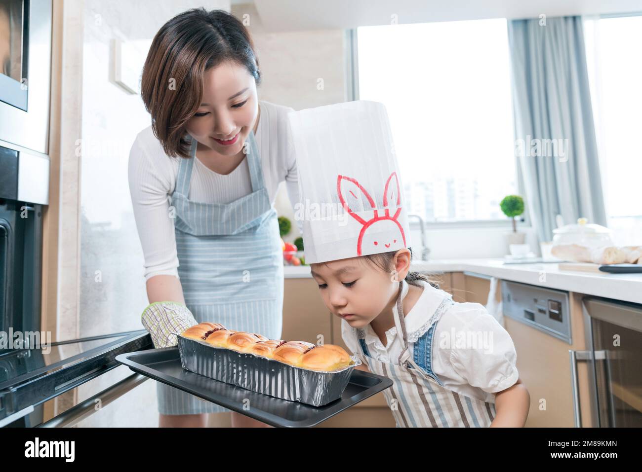 Mother and daughter two people bake bread in the kitchen Stock Photo ...