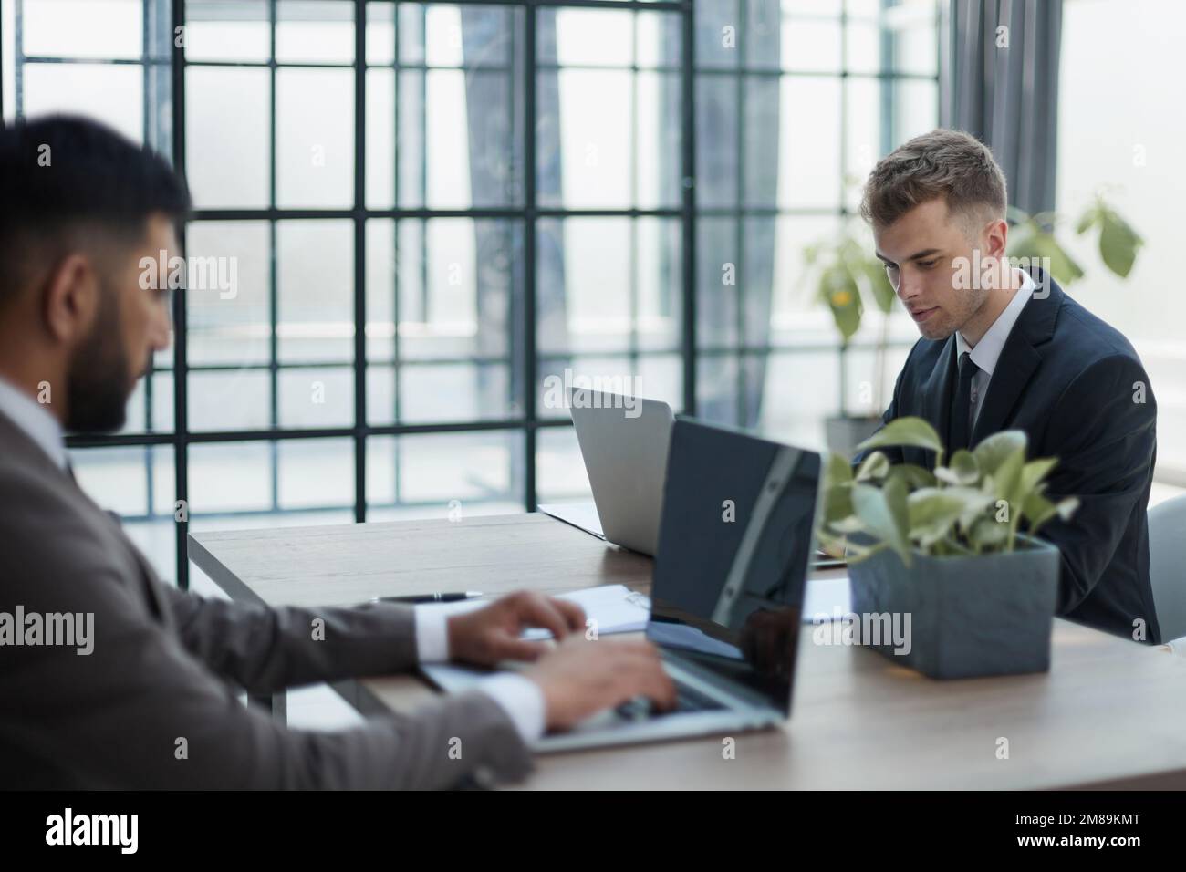 Two happy men working together on a new business project Stock Photo ...