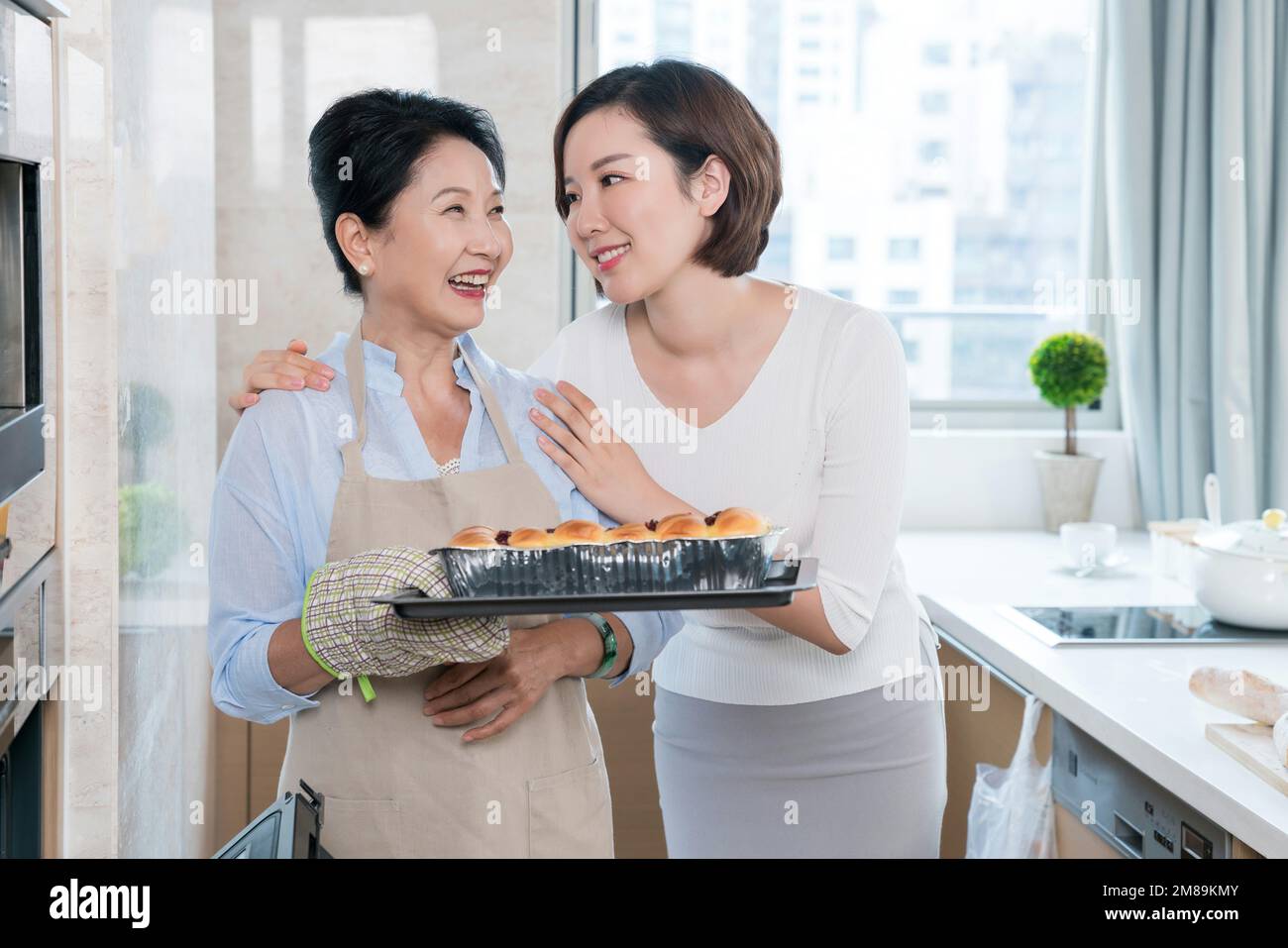 Mother and daughter two people bake bread in the kitchen Stock Photo ...