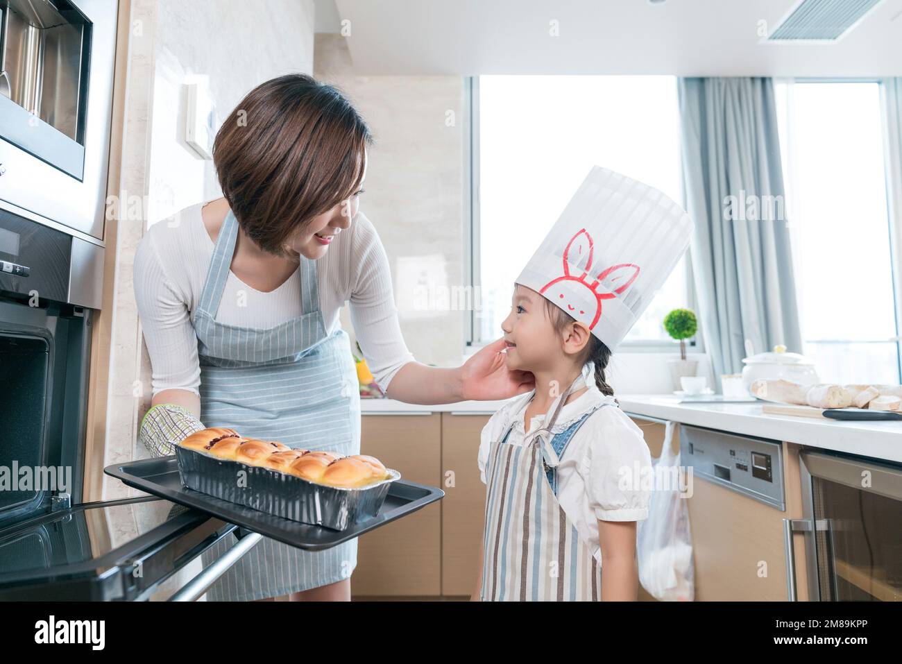 Mother and daughter two people bake bread in the kitchen Stock Photo ...