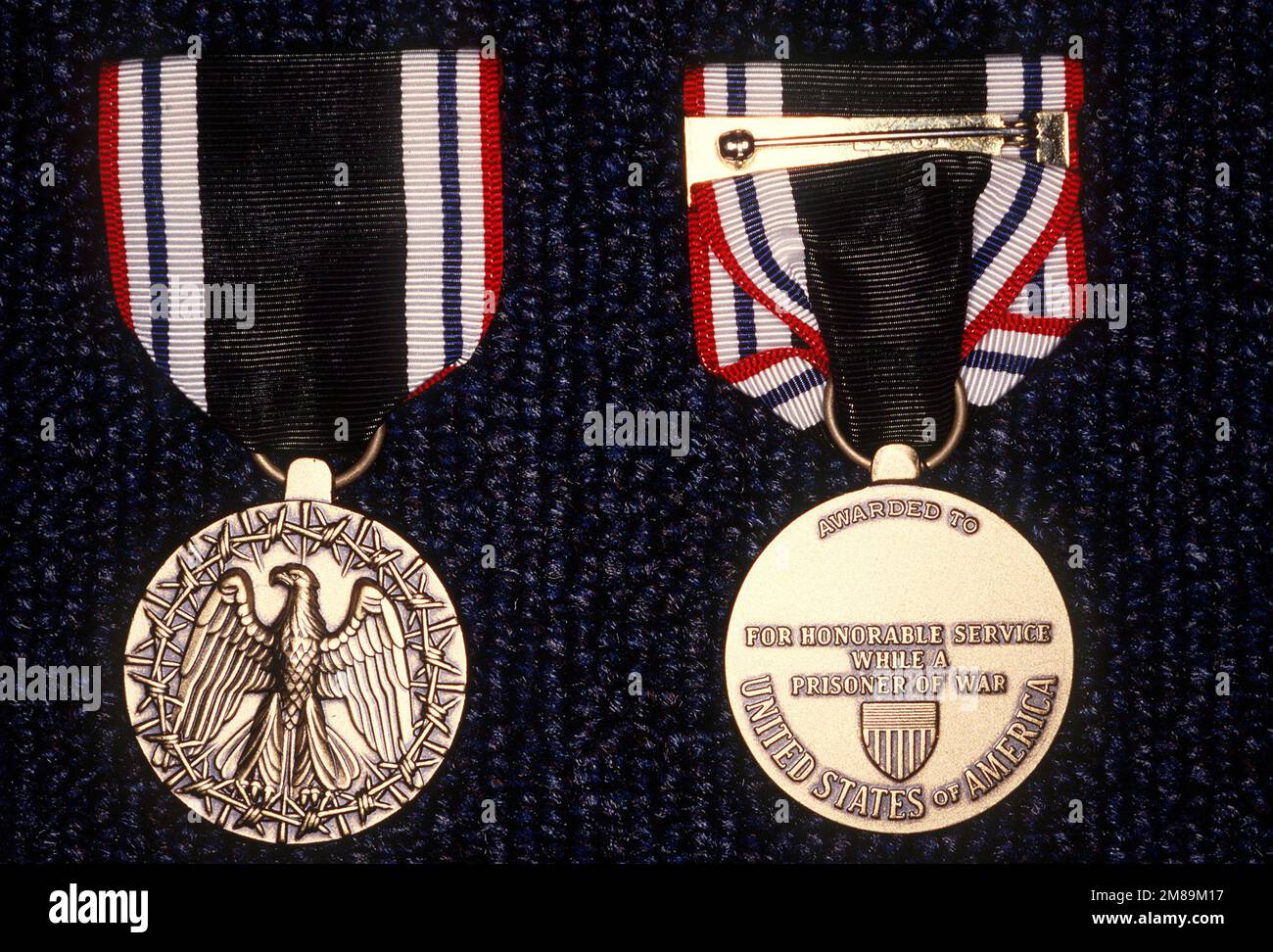 A close-up view of the front and back of the POW/MIA medal. Country ...