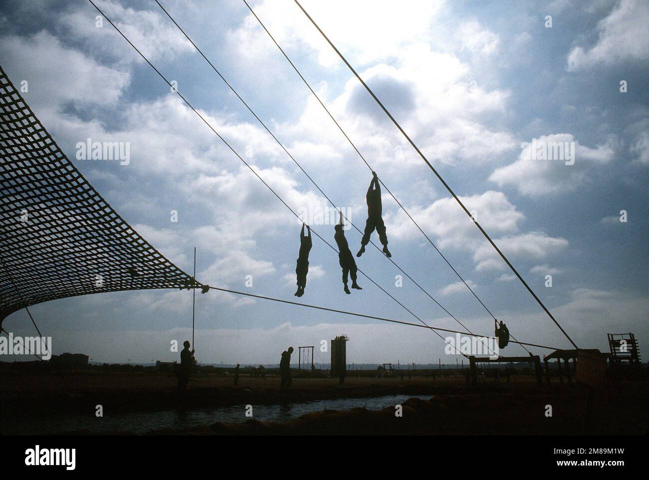 Marine recruits complete an event on the obstacle course during ...
