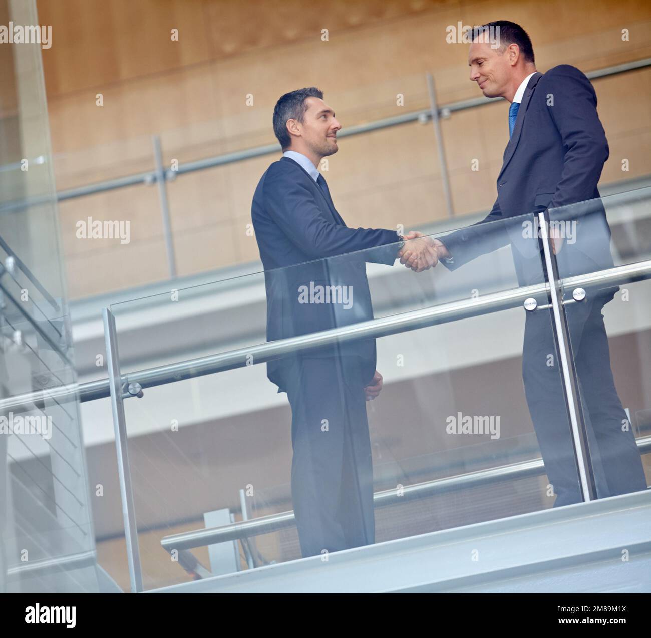 Low angle, business people and corporate handshake in modern office ...