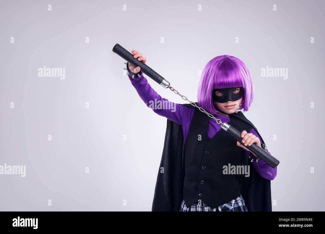 Little girl, halloween and superhero dress up with nunchucks for ...