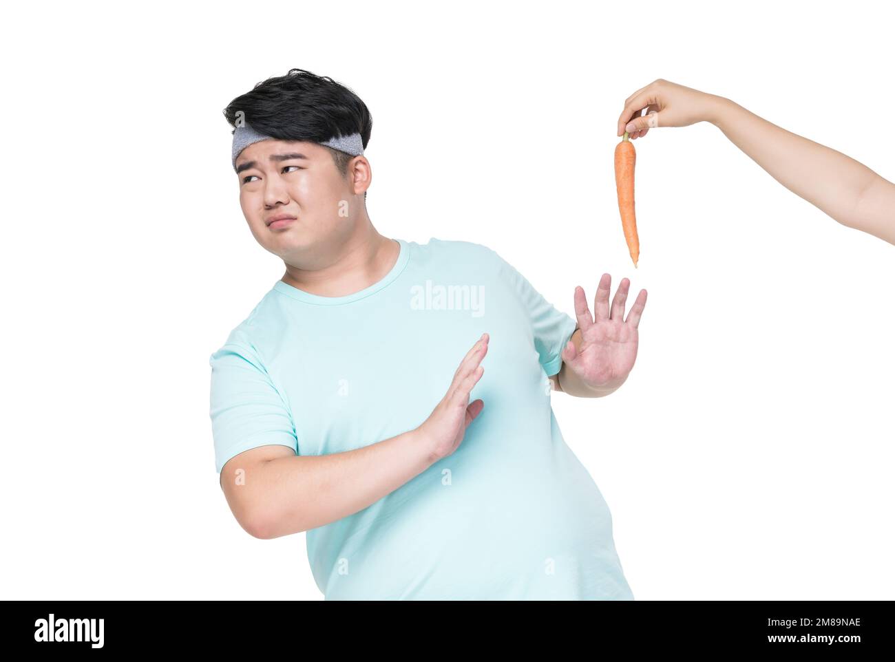 Fat young men refused to eat carrots Stock Photo - Alamy