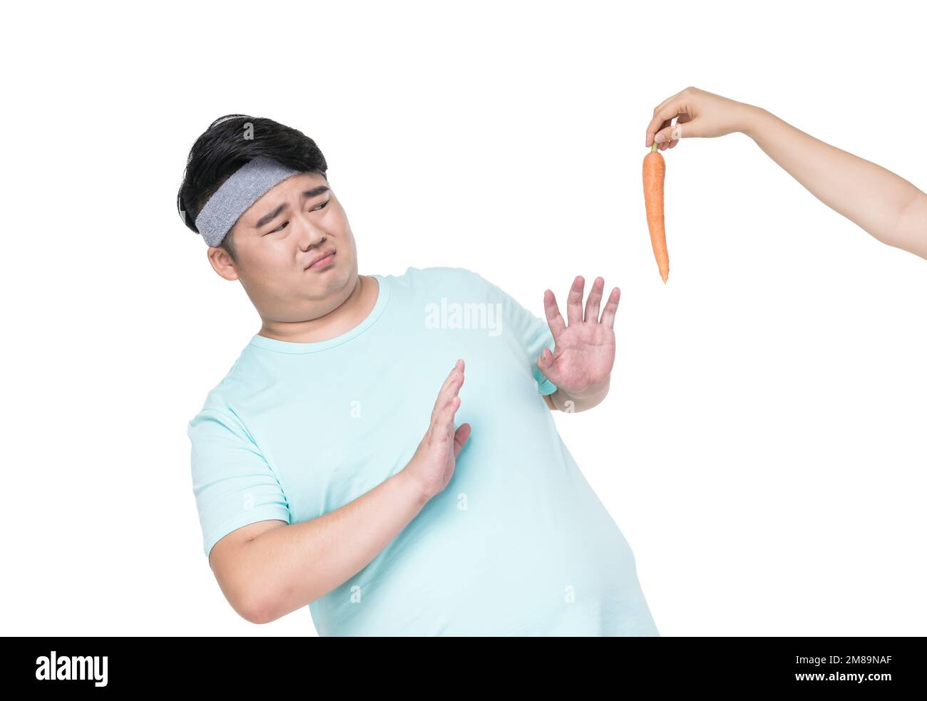 Fat young men refused to eat carrots Stock Photo - Alamy