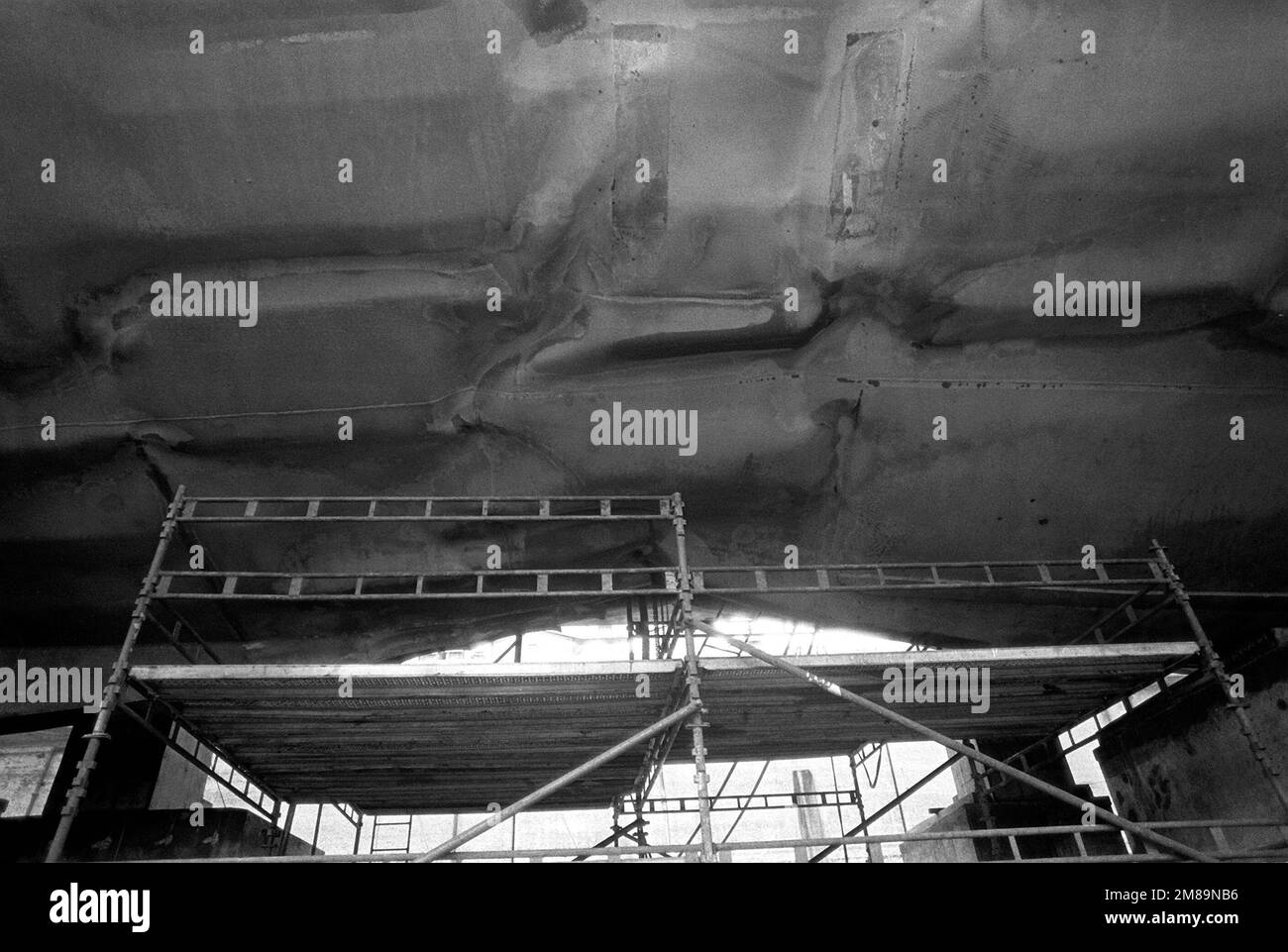 A close-up view of damage to the hull of the guided missile frigate USS ...